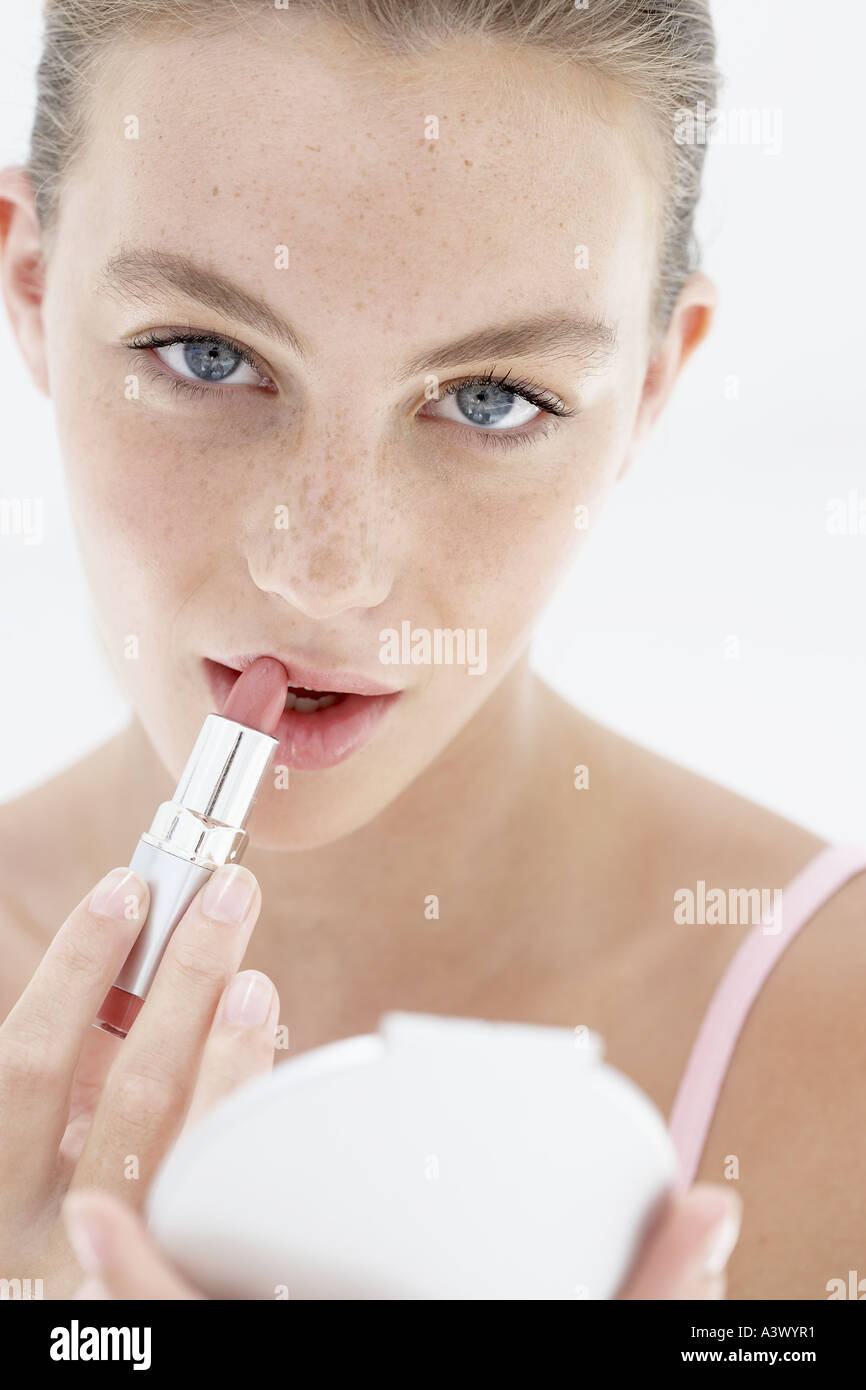 A young woman applying lipsticks Stock Photo - Alamy