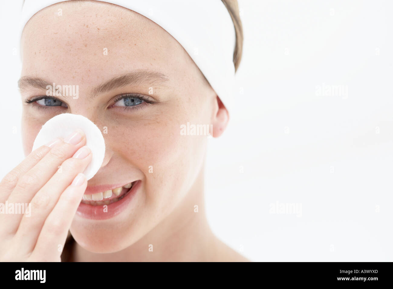 A young woman wiping face with cotton pad Stock Photo - Alamy