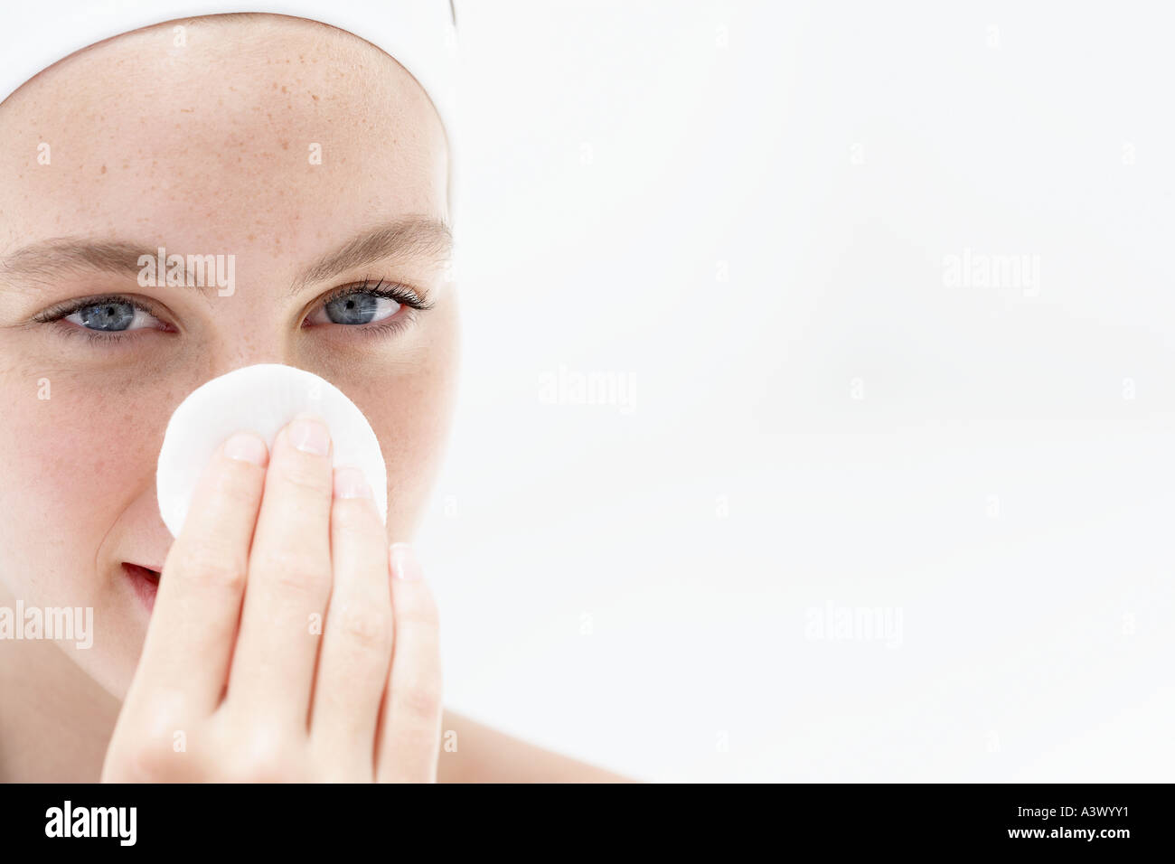 A young woman wiping face with cotton pad Stock Photo - Alamy