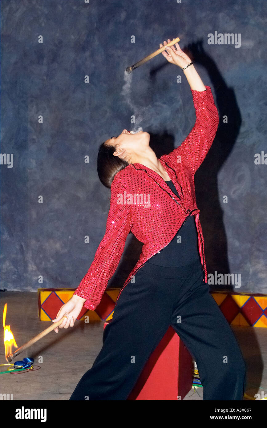 Young circus girl eating fire Stock Photo - Alamy