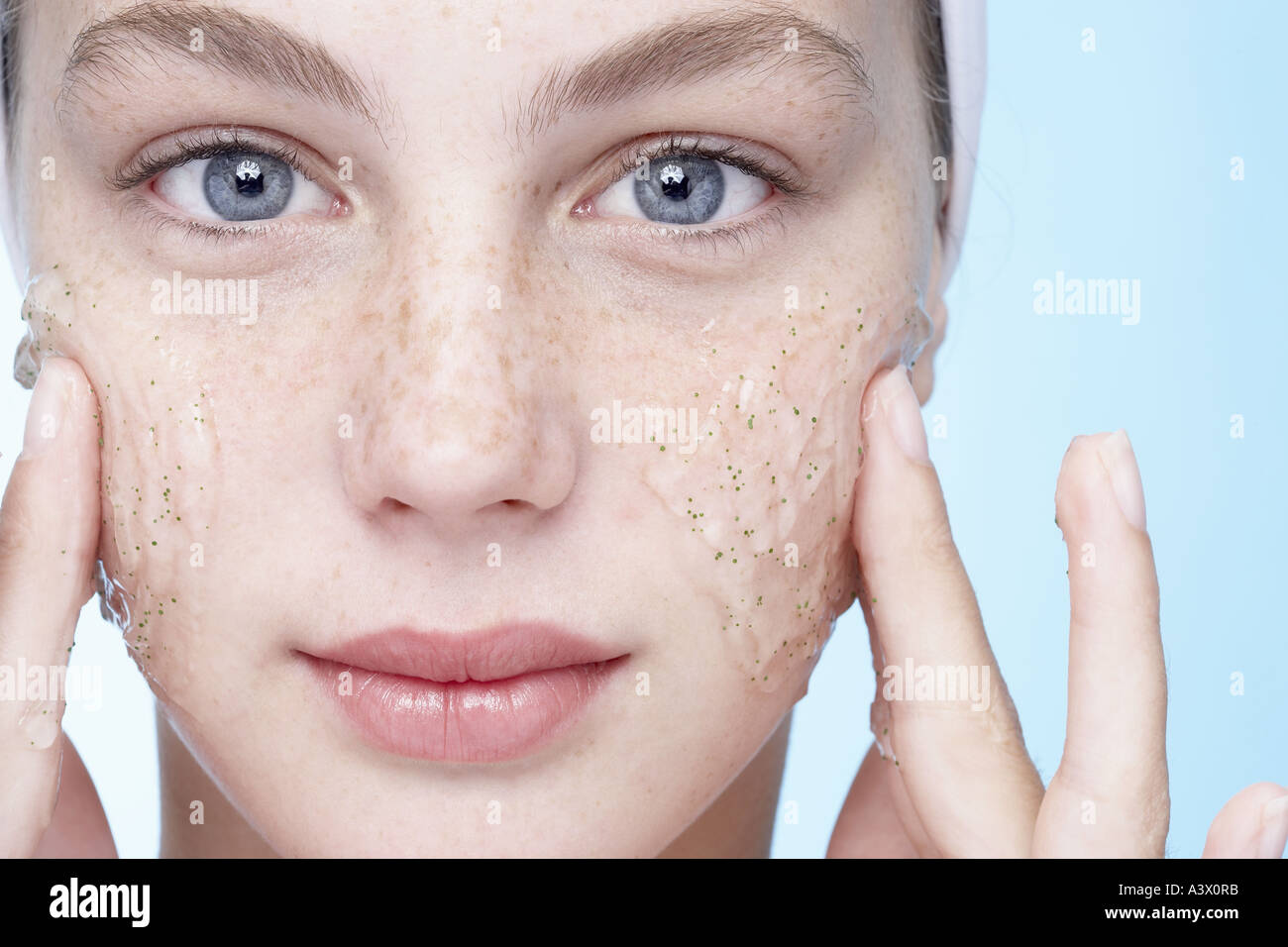 A young woman applying gel on her face Stock Photo - Alamy