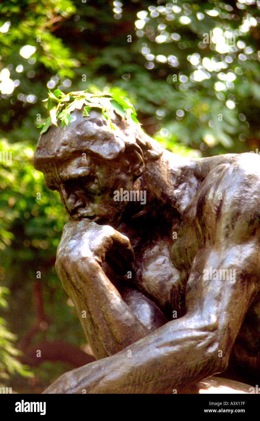 Copy of Auguste Rodin's The Thinker sculpture with green leaves on head ...