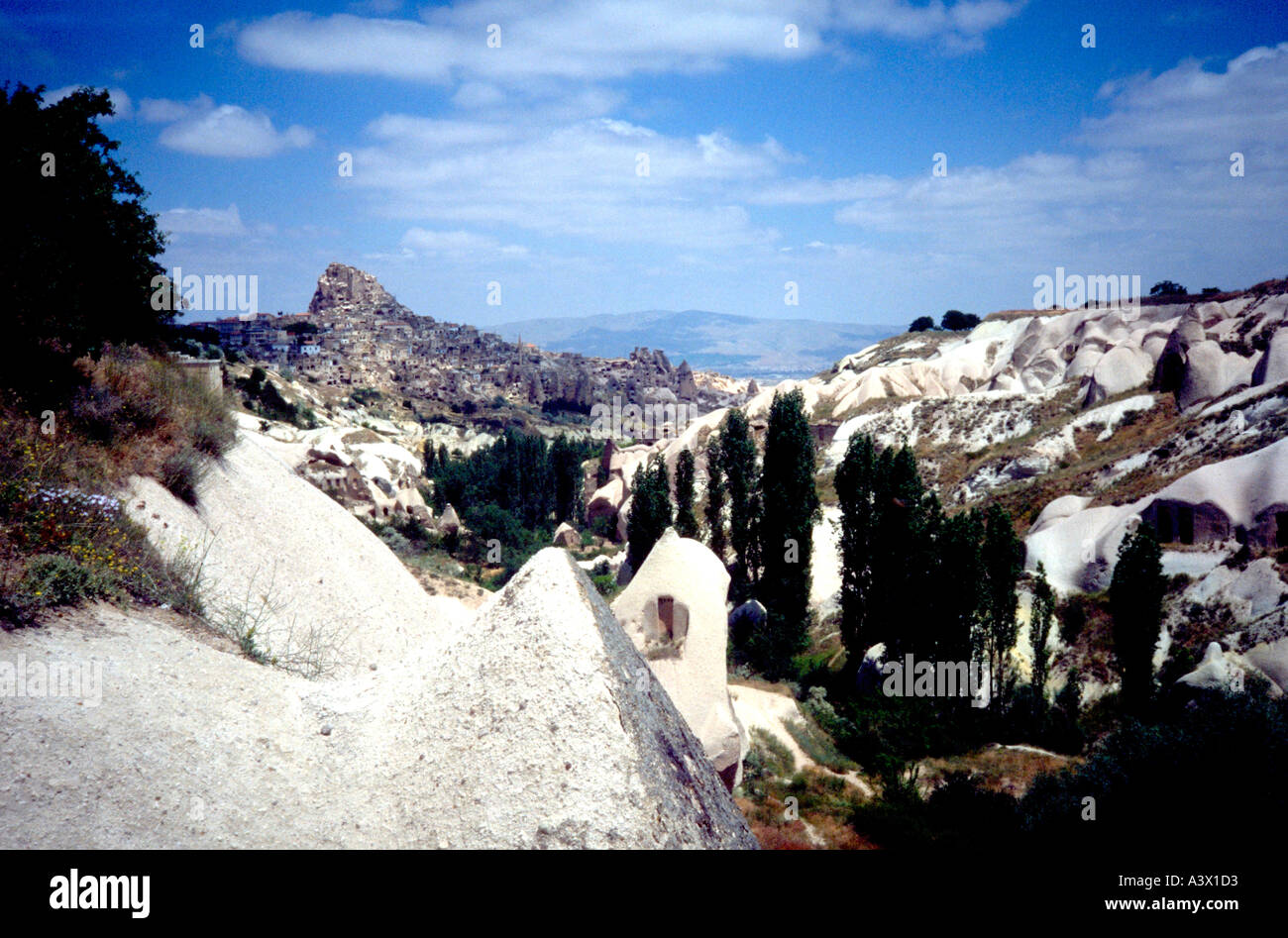 Volcanic area with ancient cliff dweller homes on the horizon. Turkey ...