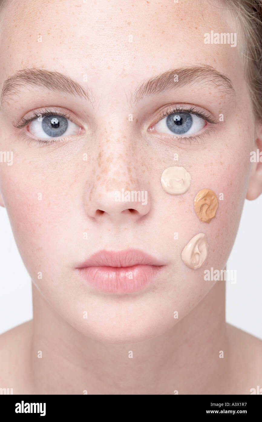 A young woman with foundation on her face Stock Photo - Alamy
