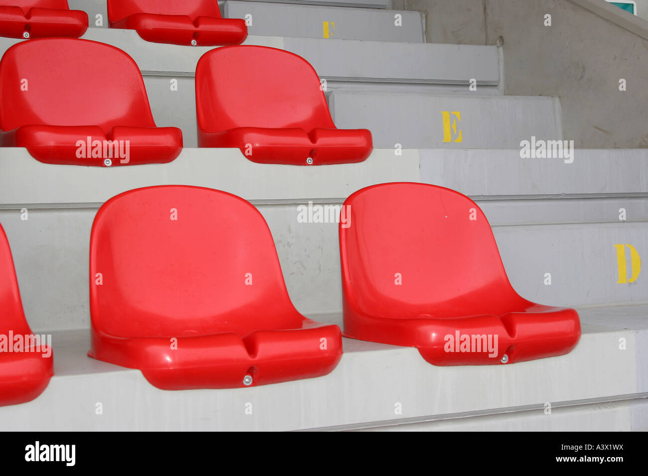 red seats on a stand Stock Photo - Alamy