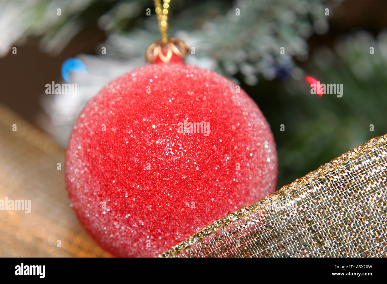 christmas decorative red ball and ribbon with tree in background Stock ...
