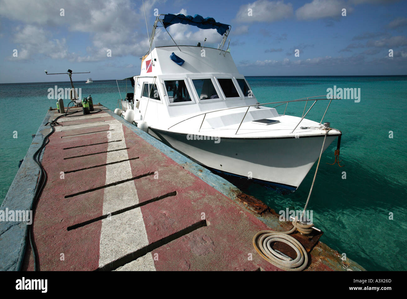 A dive boat is moored on the jetty in the seaside resort of Maria La ...