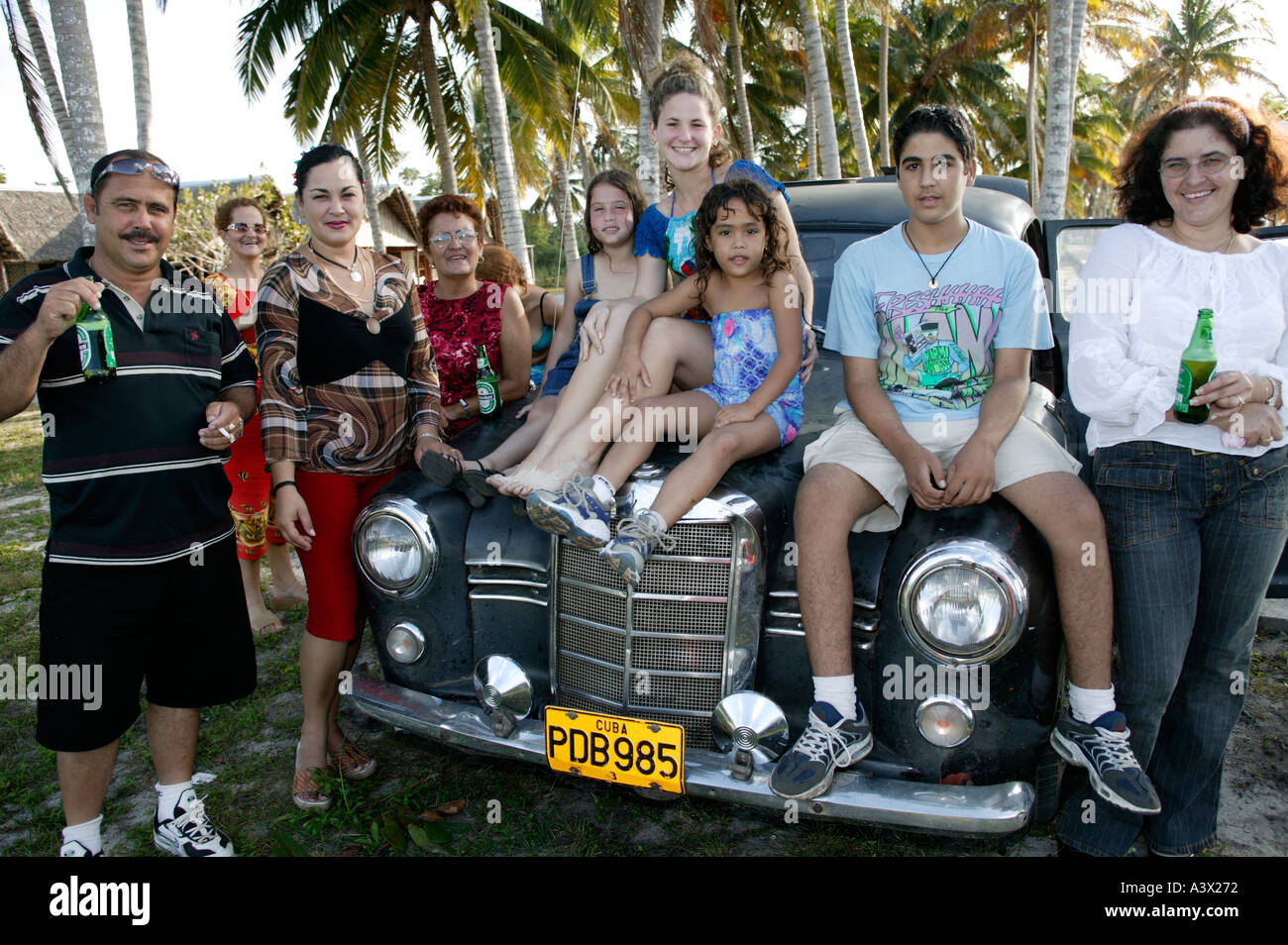 A large Cuban family pose with their car during a holiday at the ...