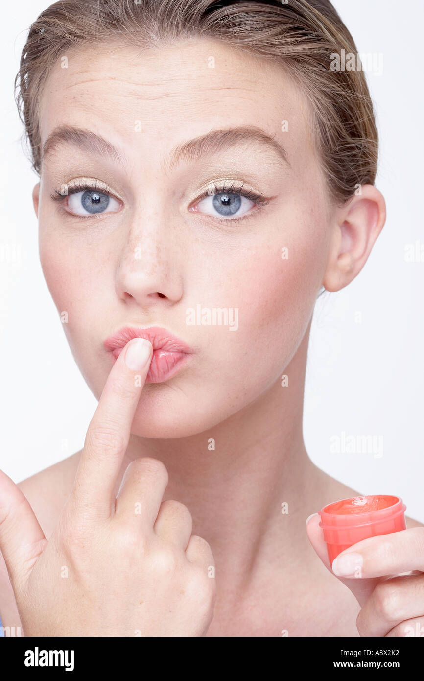 Applying lip cream hi-res stock photography and images - Alamy