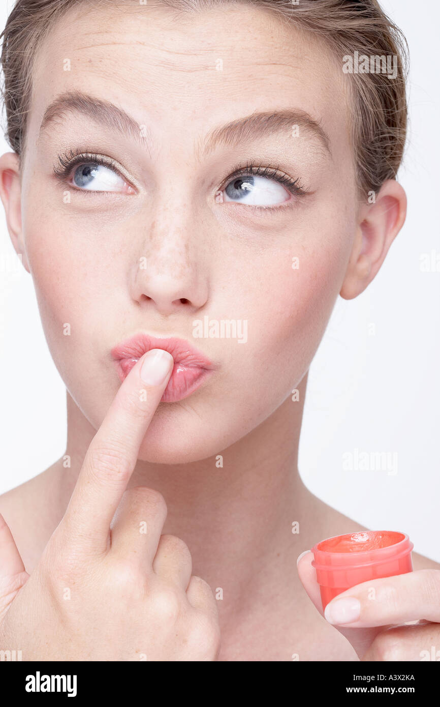 Applying lip cream hi-res stock photography and images - Alamy
