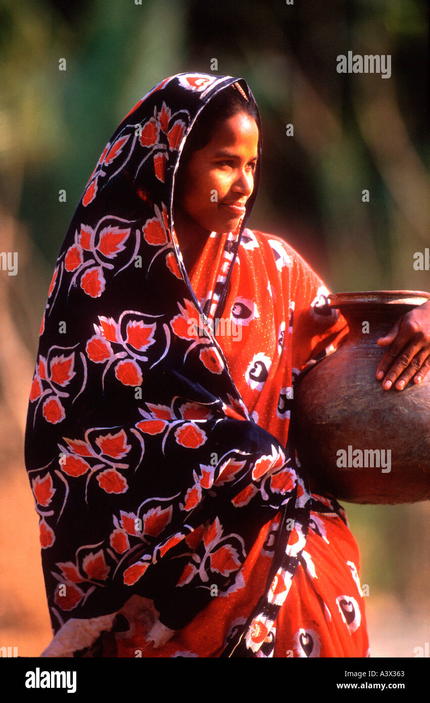 Young woman collects well water in rural Bangladesh Stock Photo - Alamy