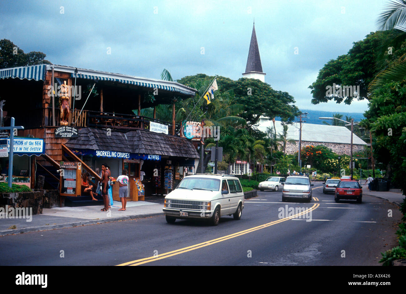 Restaurant and shops along main beach road in tourist holiday town Kona ...
