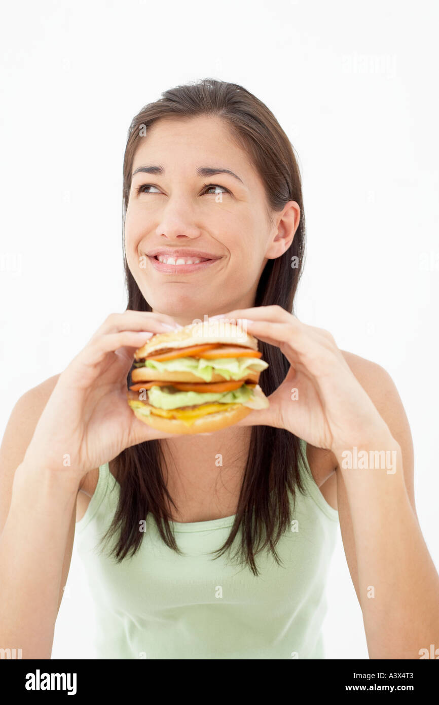 A young woman eating a hamburger Stock Photo - Alamy