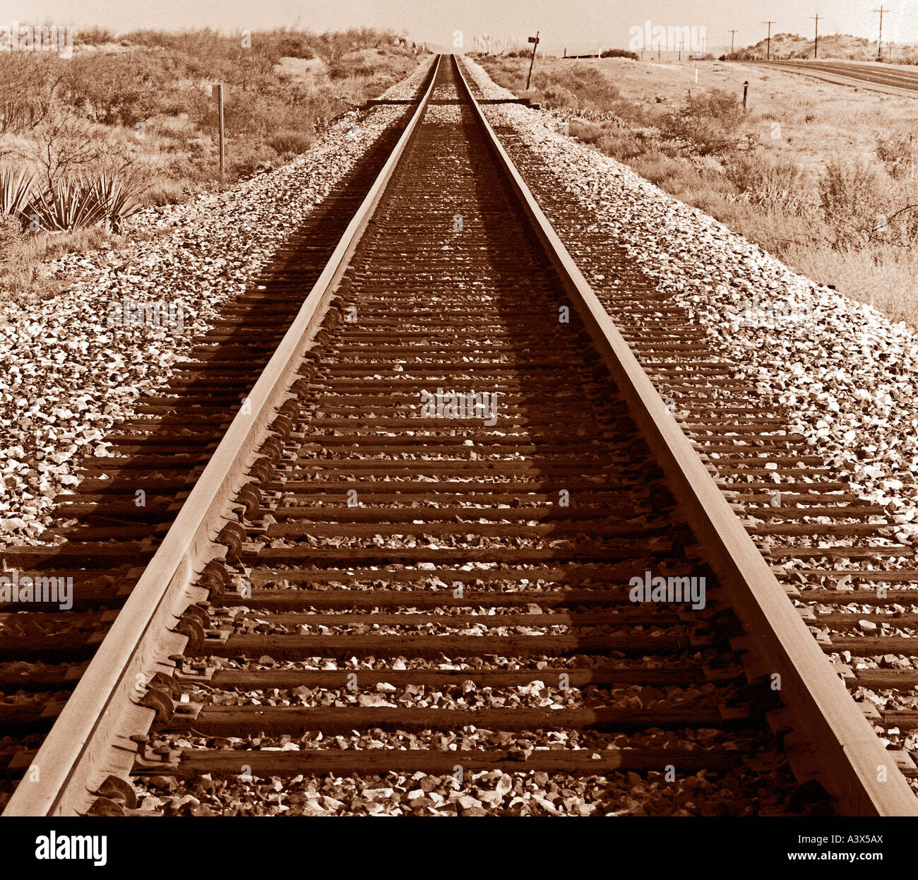 Railroad tracks along a road in southern Utah Stock Photo - Alamy