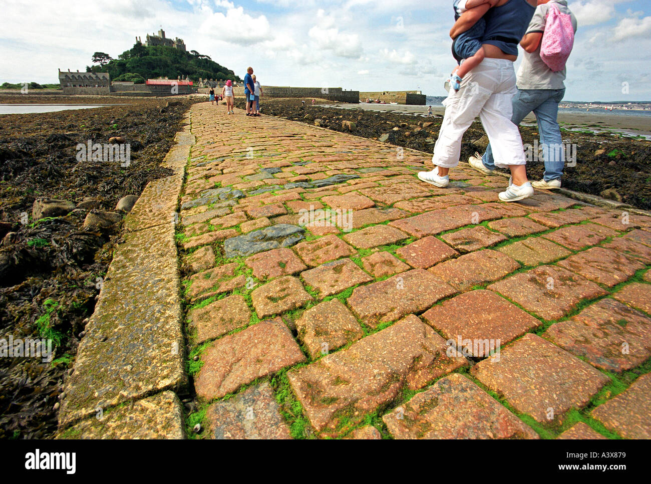 Walkers on the pathway or causeway leading to St Michaels Mount in ...