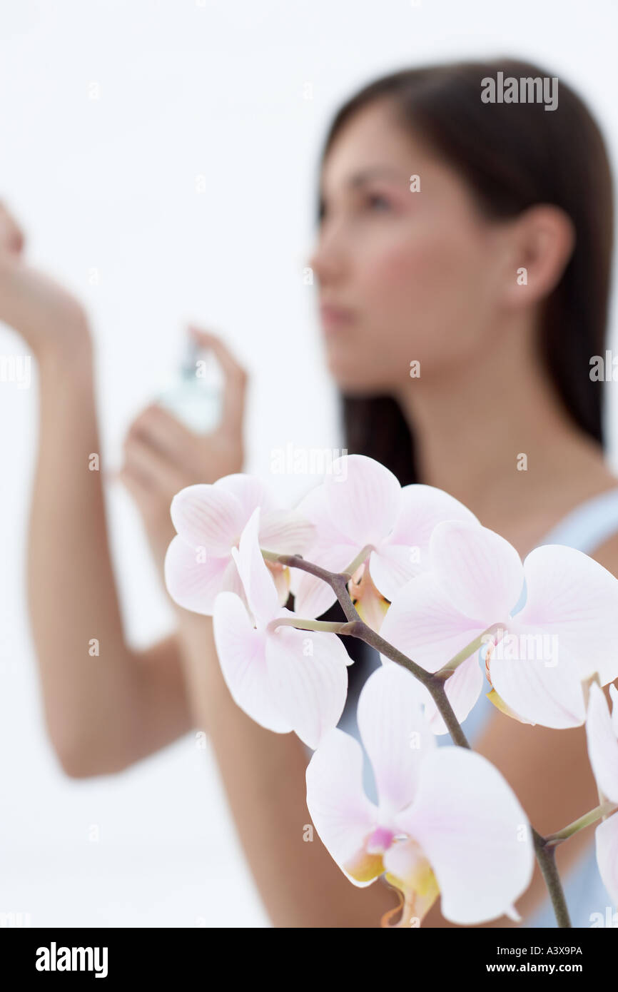 A young woman behind a stem of flowers Stock Photo - Alamy