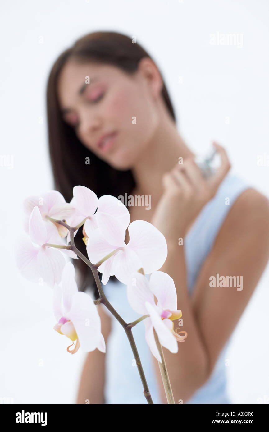 A young woman behind a stem of flowers Stock Photo - Alamy