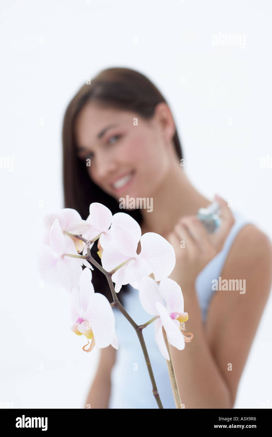 A young woman behind a stem of flowers Stock Photo - Alamy