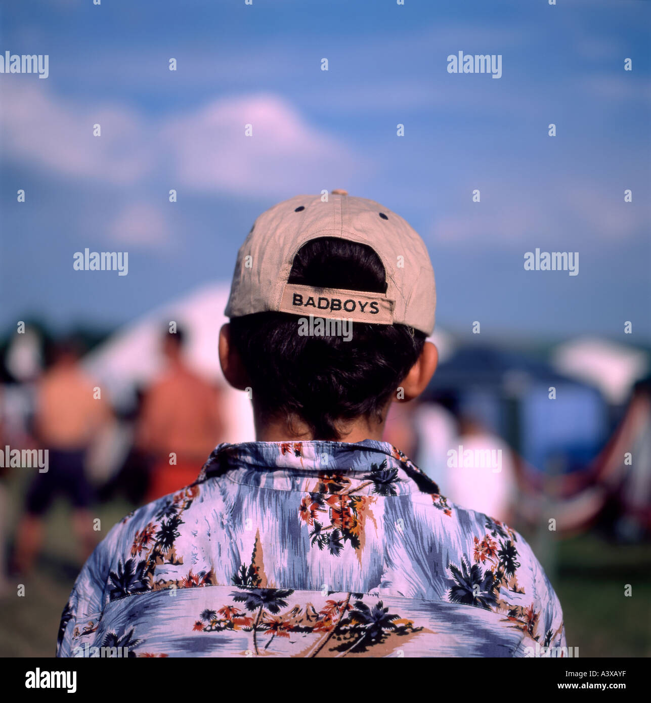 Back view of young teen boy 11, 12 or 13 wearing Badboys baseball cap ...