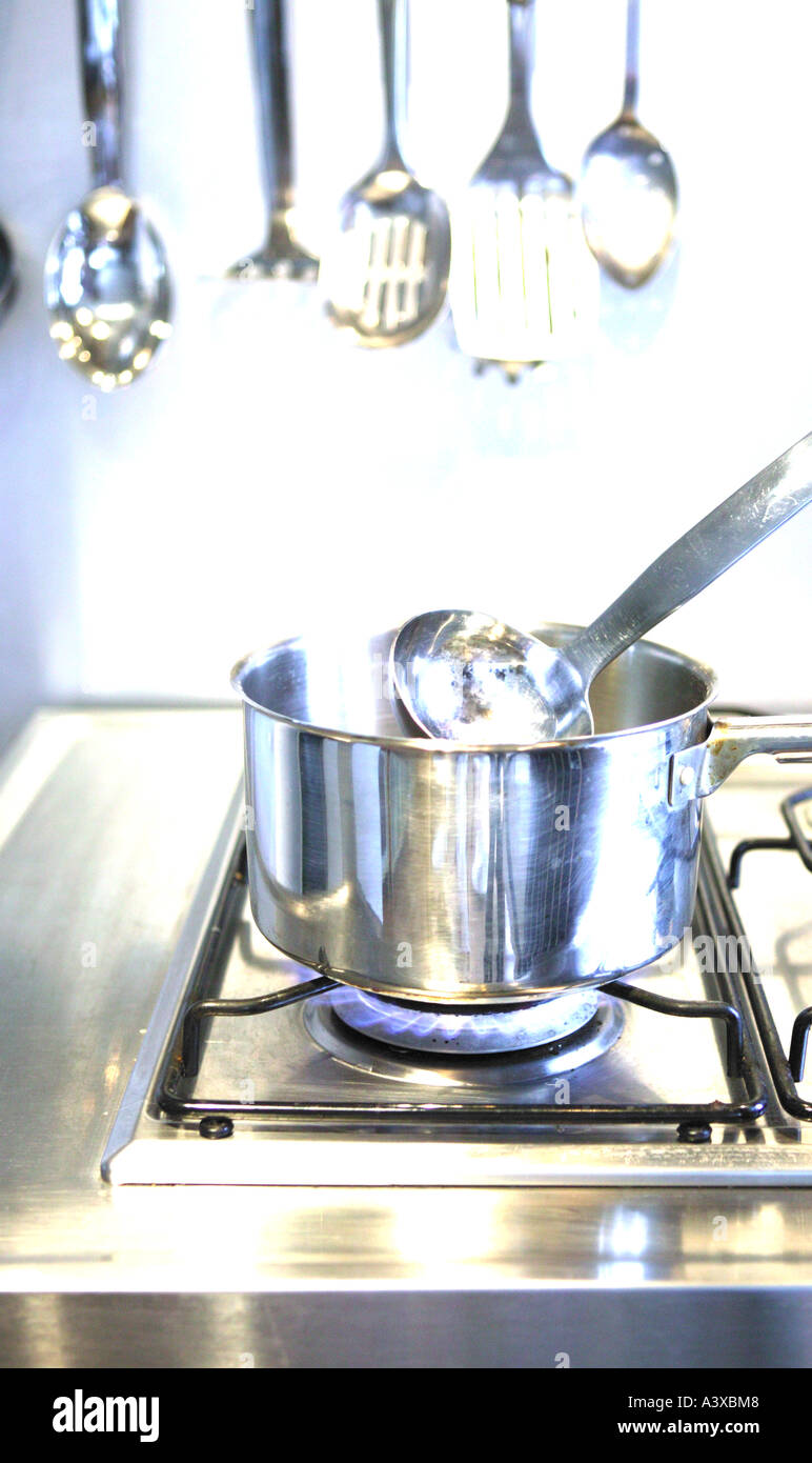 Stainless steel gas hob and utensils Stock Photo - Alamy