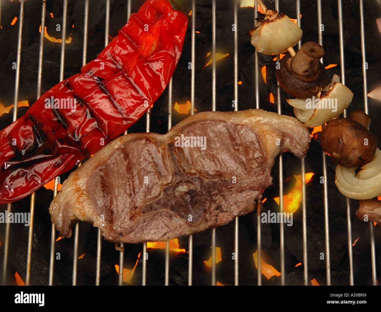 Lamb chop, red pepper and brochette on a barbecue Stock Photo - Alamy