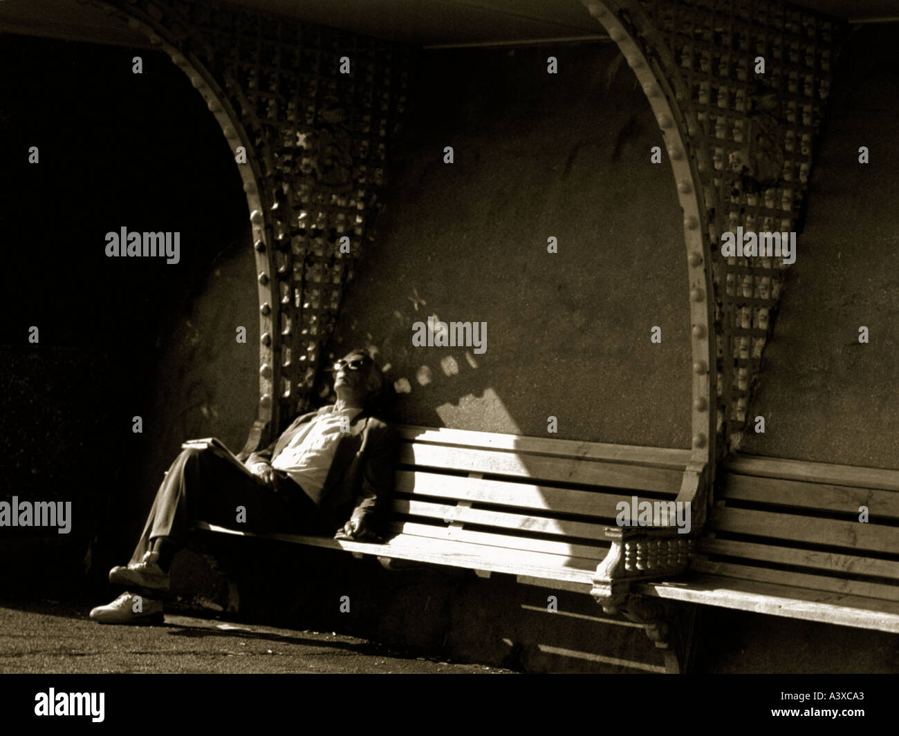 Snoozing on bench hi-res stock photography and images - Alamy