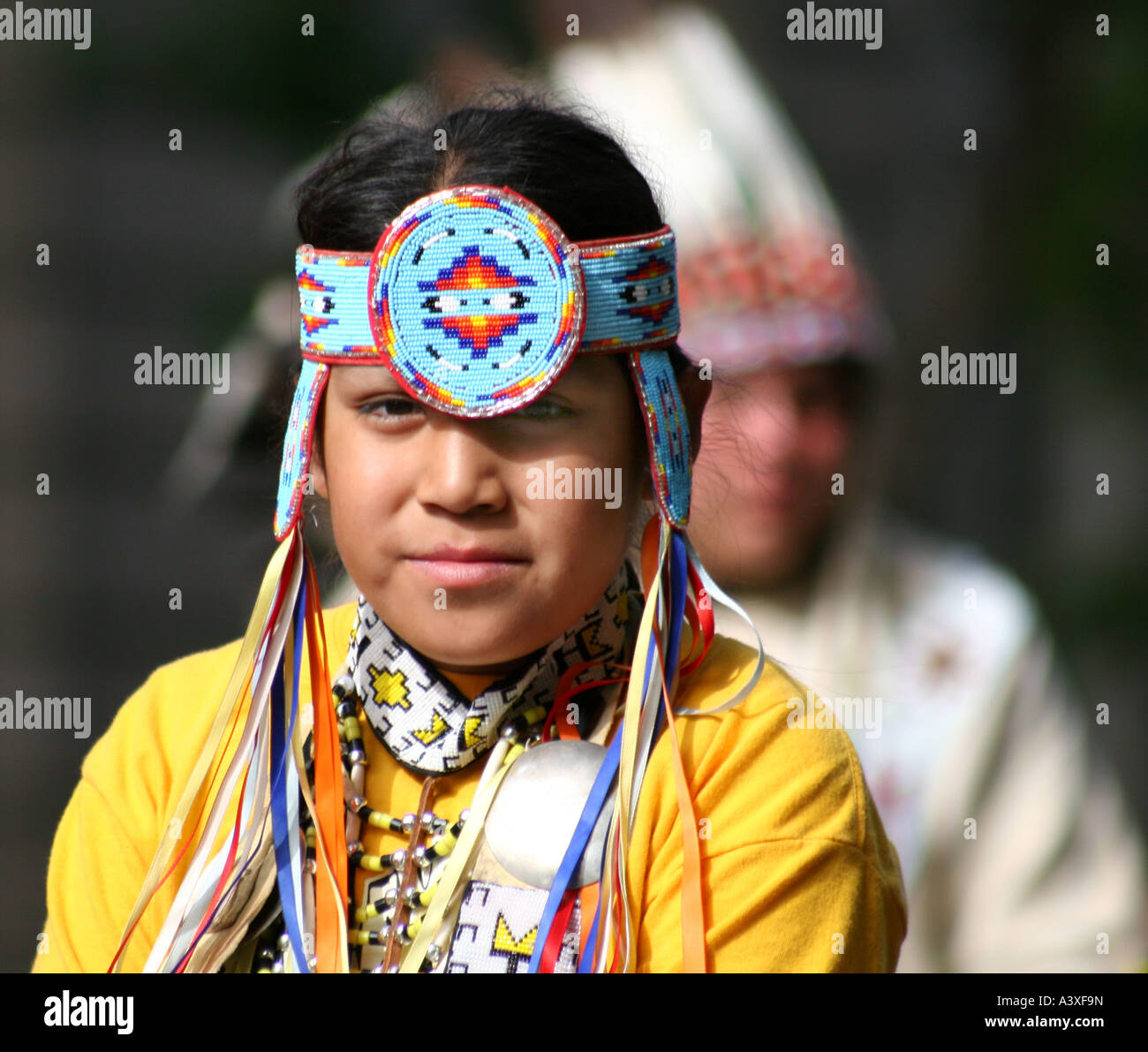 Young Native American wearing traditional hand band and dress at the ...