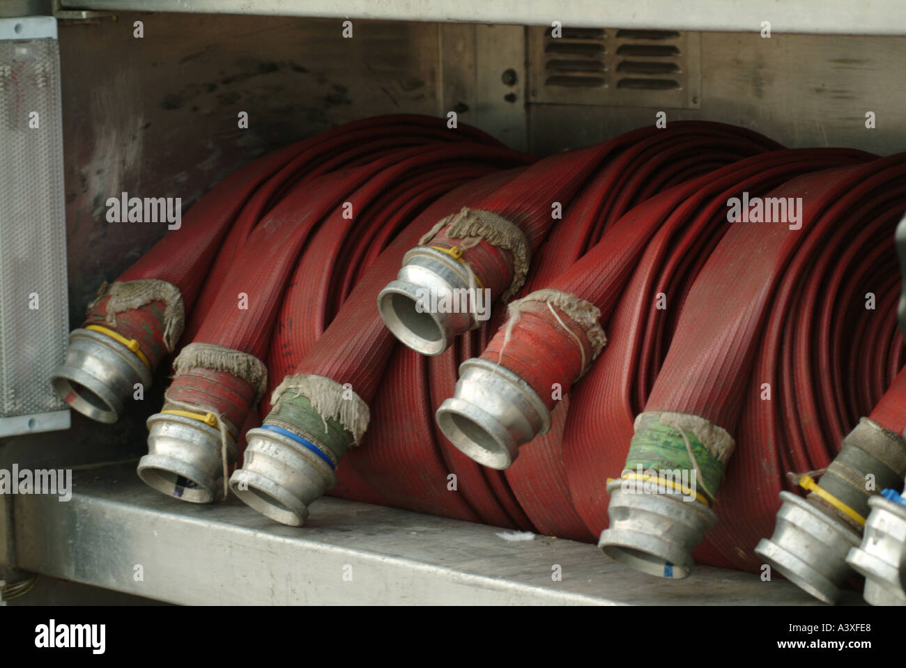 firehose fire hose water brigade fireman man men Stock Photo - Alamy