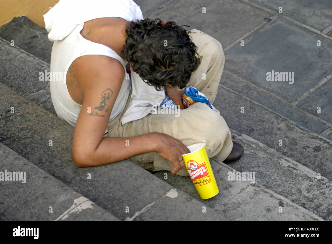 Sleeping beggar on steps of Catholic Church in Miami Florida USA ...