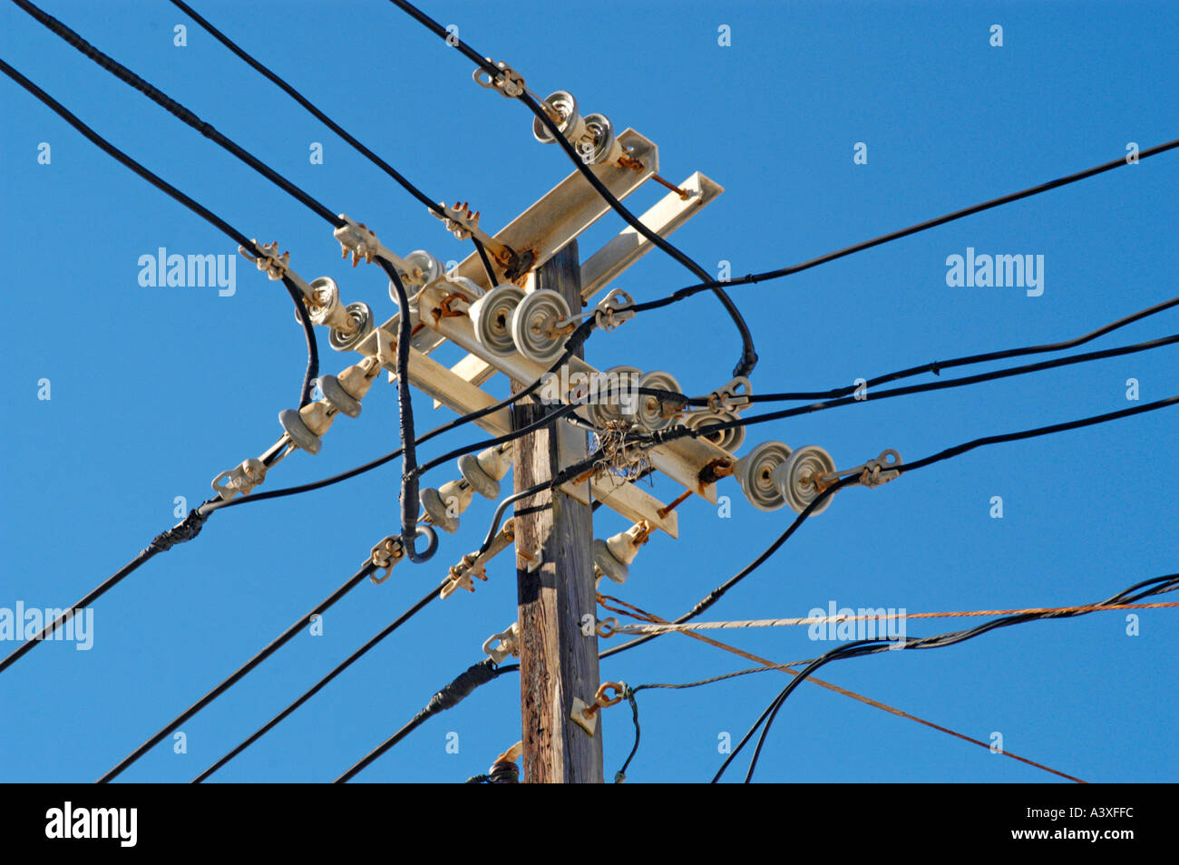 Over loaded electric power lines on wooden pole moving power over the ...