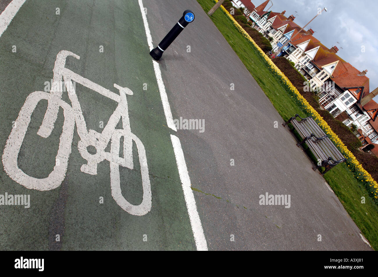 A white painted symbol of a bicycle on the tarmac of a cycle path next ...