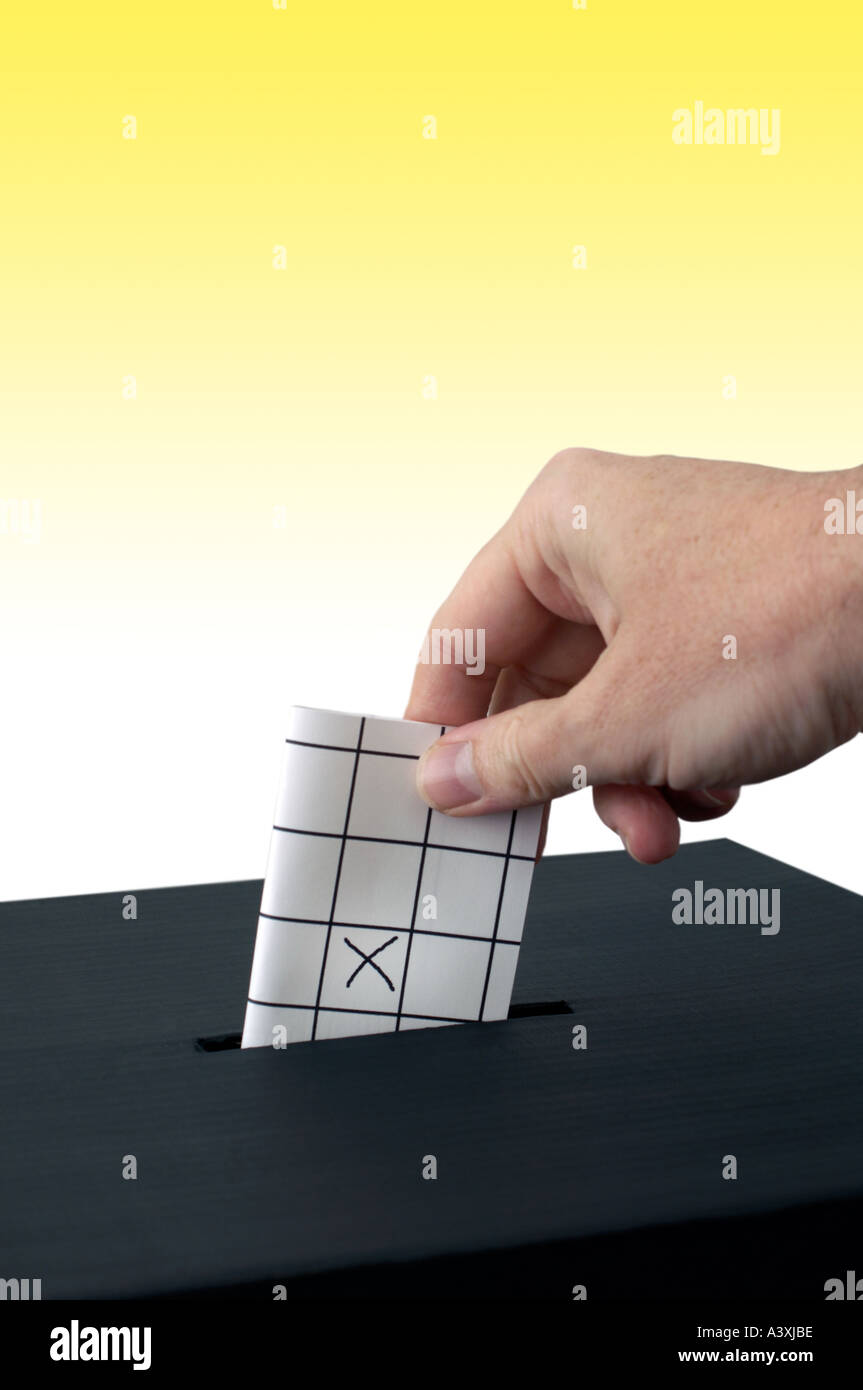 hand putting a vote into a ballot box Stock Photo - Alamy