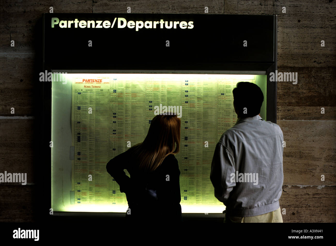 Passengers viewing the depature timetable at Termini railway station ...