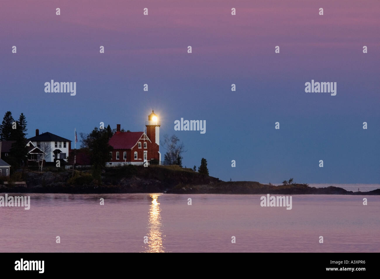 Eagle Harbor Lighthouse With Beam of Light Reflecting Across Water at ...