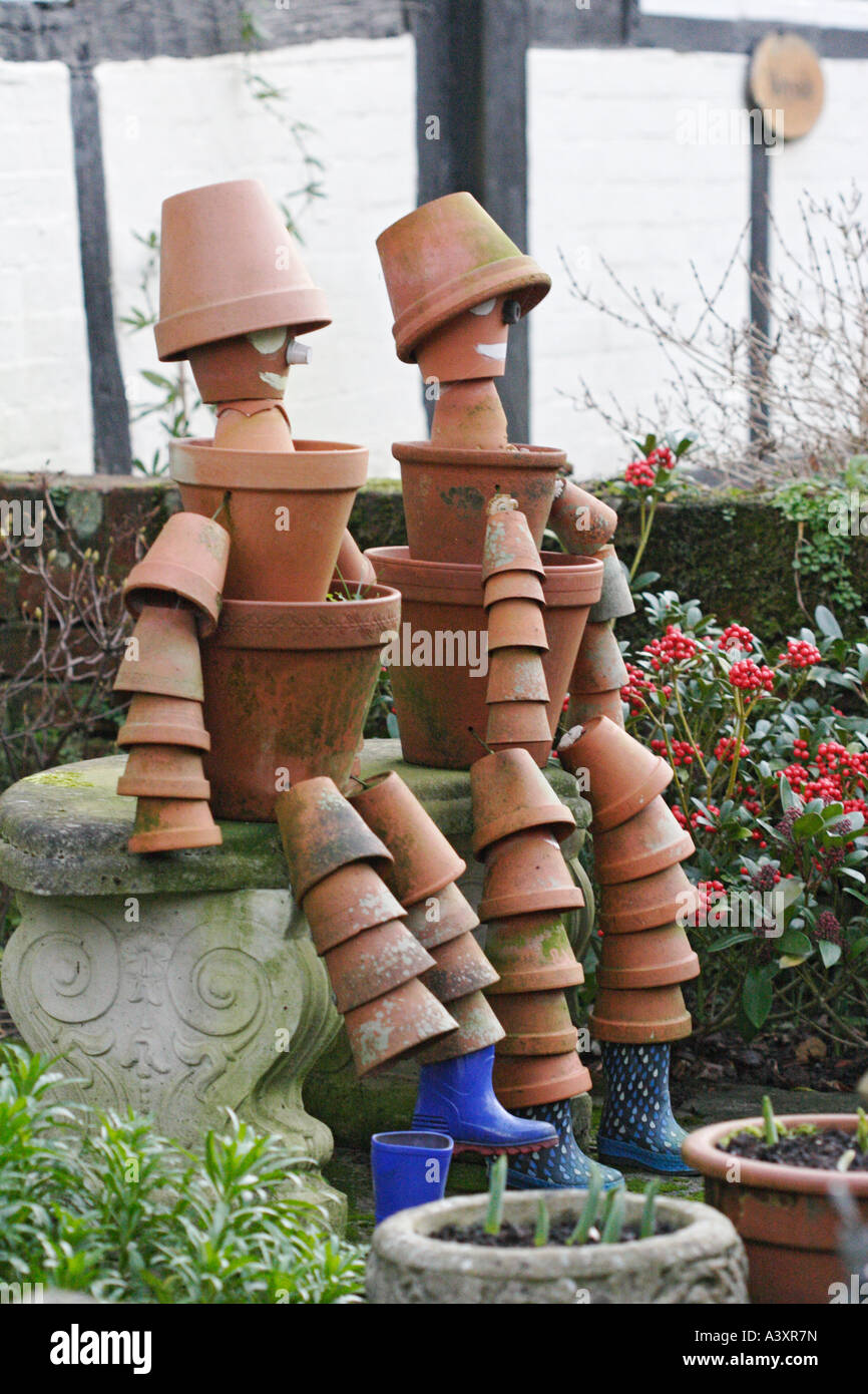 Two flowerpot men sitting in a garden Stock Photo - Alamy