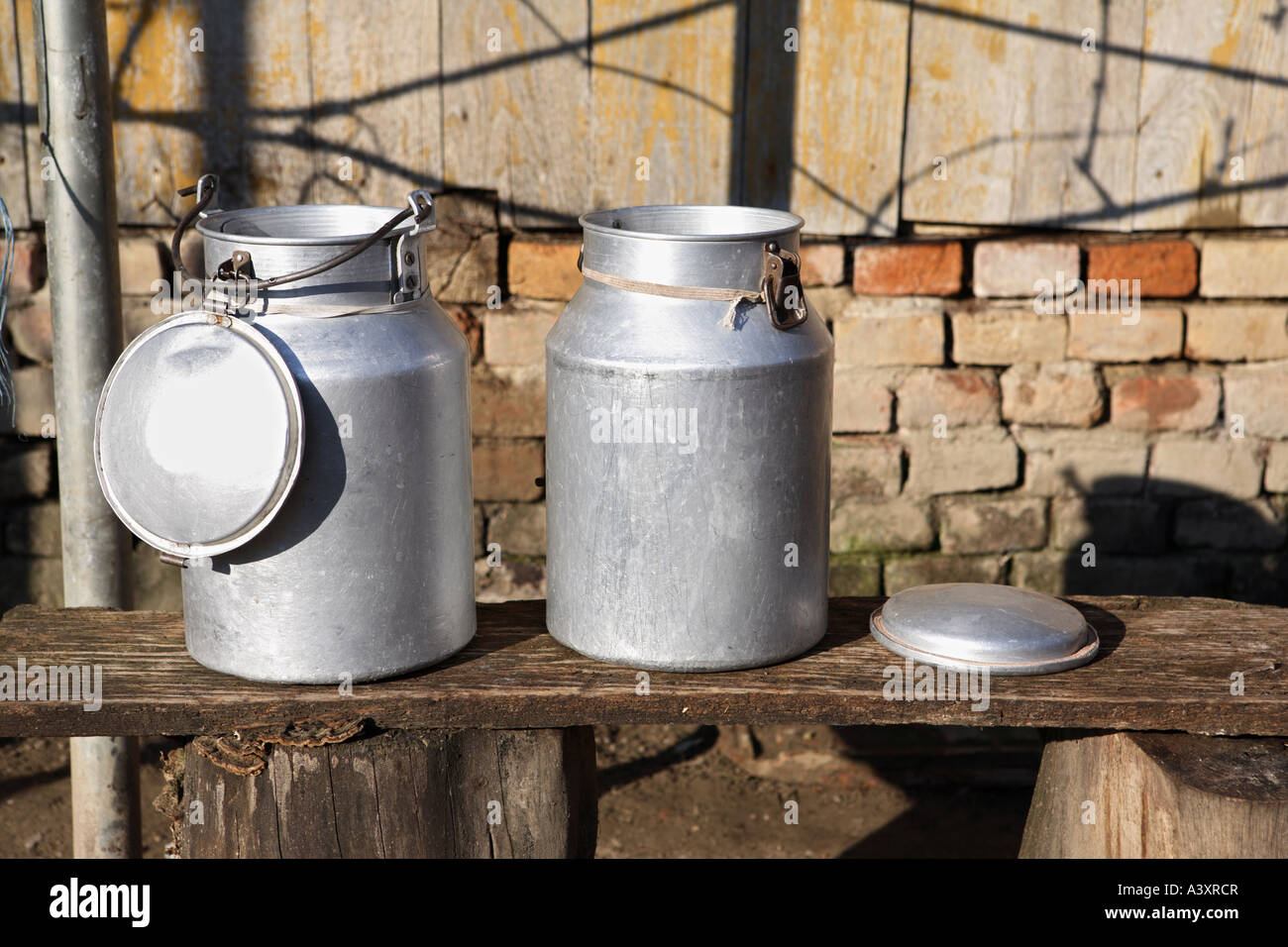 Two tin milk containers Stock Photo - Alamy