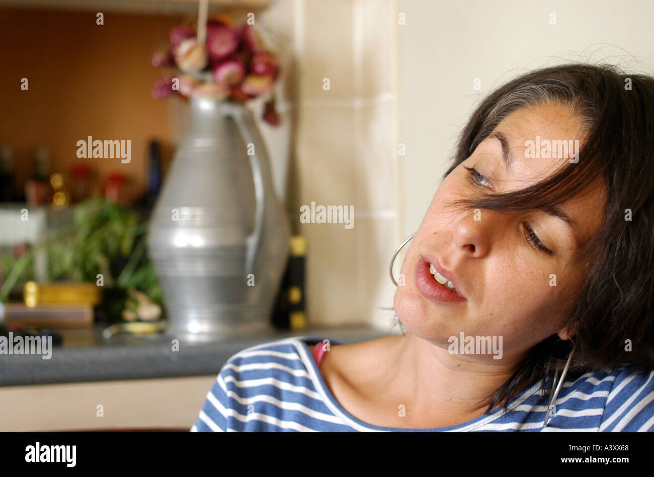 sleeping woman leaning against wall with dark hair Stock Photo - Alamy