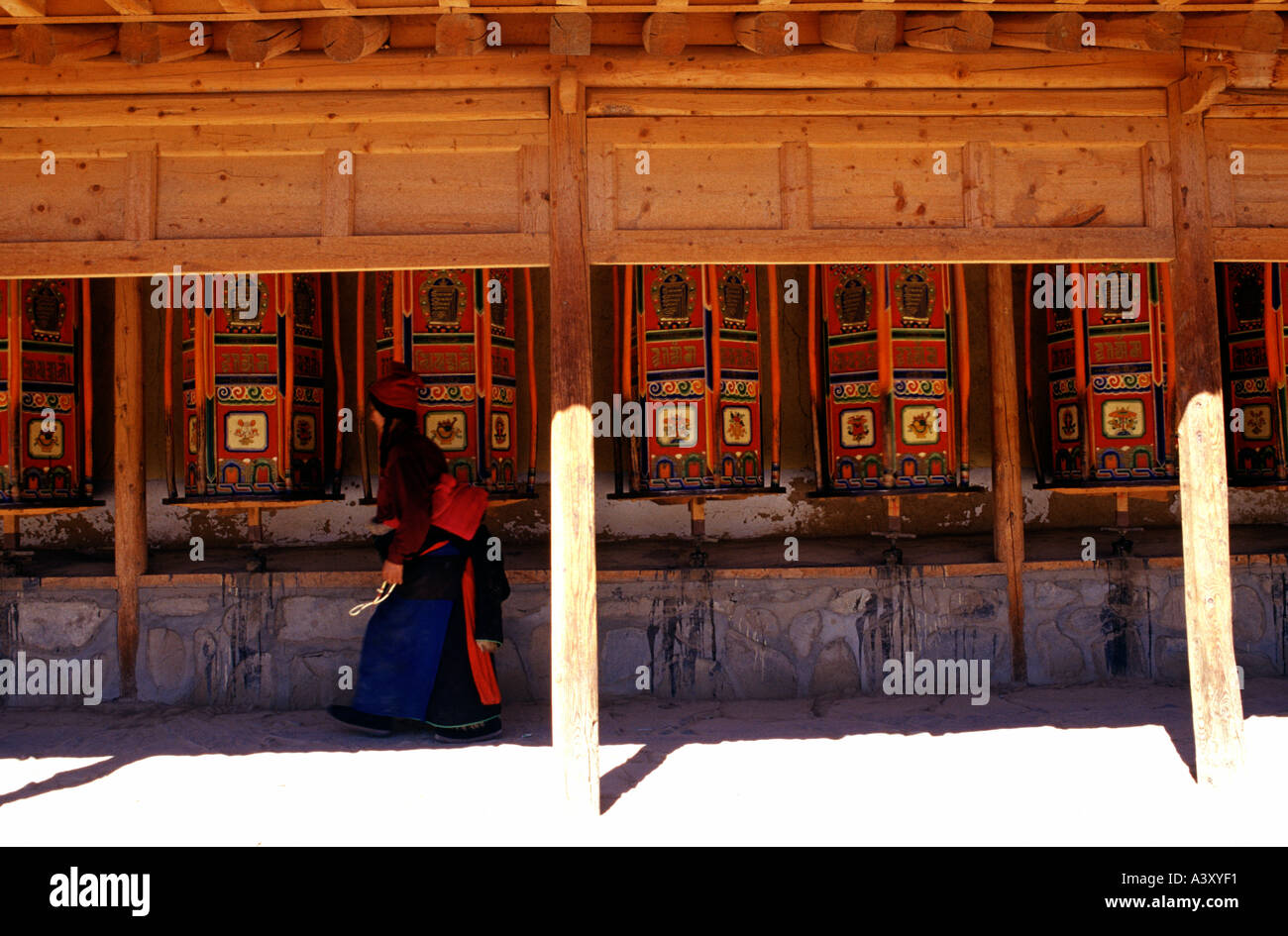 Buddhist devotee spinning prayer wheels at Gong Tang pagoda in Labrang ...