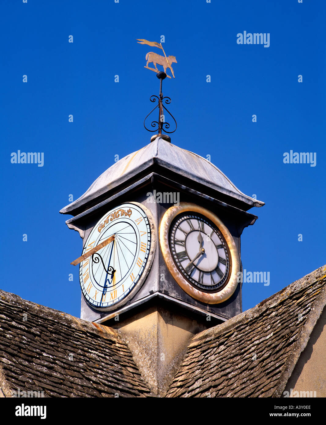Sundial and clock on top of the Buttercross building in Witney town ...