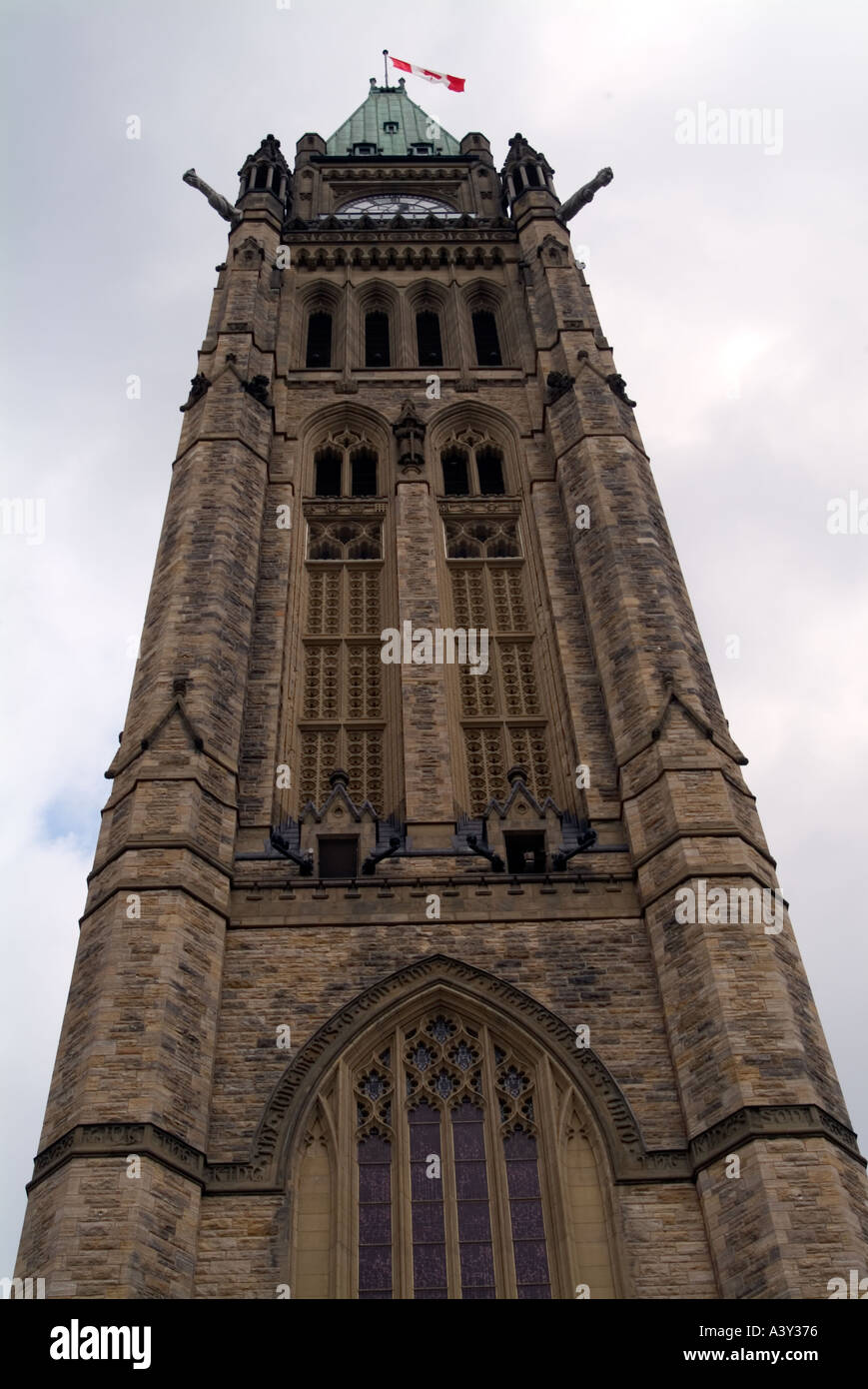 Peace Tower front view looking up Clock Canadian Flag flying Parliament ...