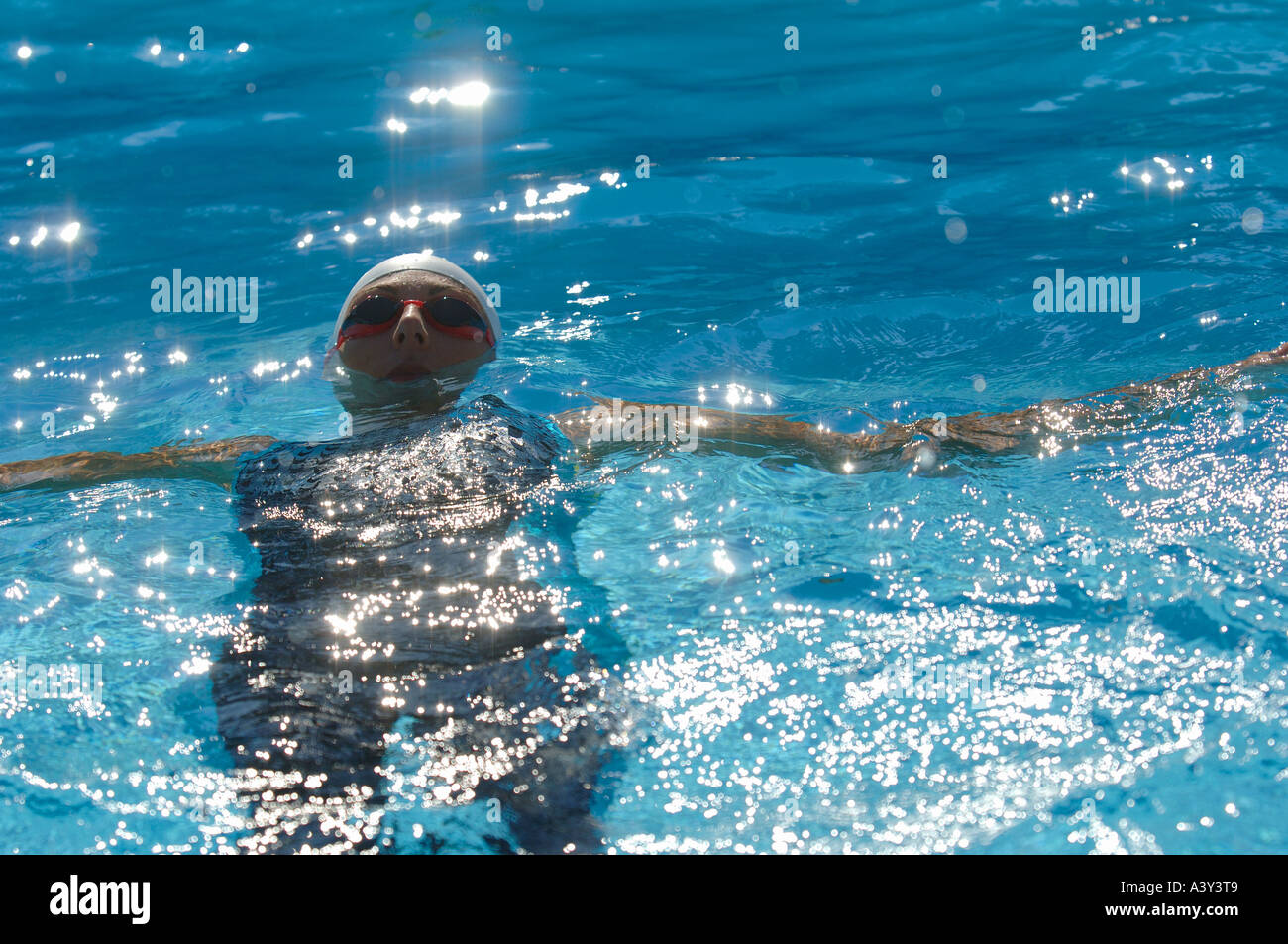 Front View of Female Swimmer Swimming Backstroke Stock Photo - Alamy