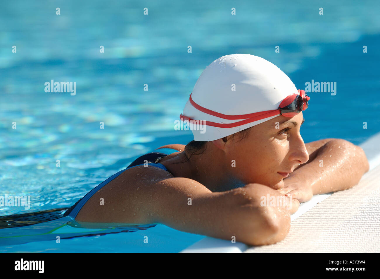Female Swimmer Leaning on Poolside Stock Photo - Alamy
