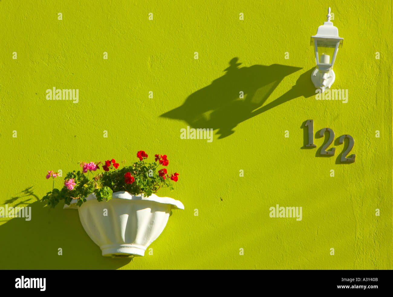 Geraniums in ornaments on wall of historic Cape Malay homes in Cape ...
