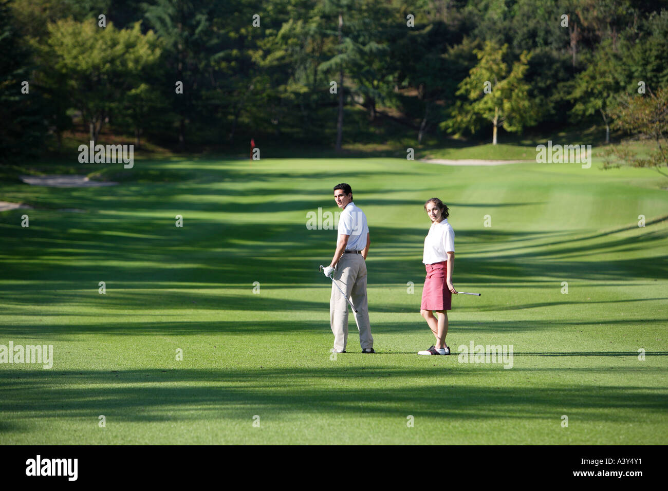 Couple Standing on a Golf Course Stock Photo - Alamy