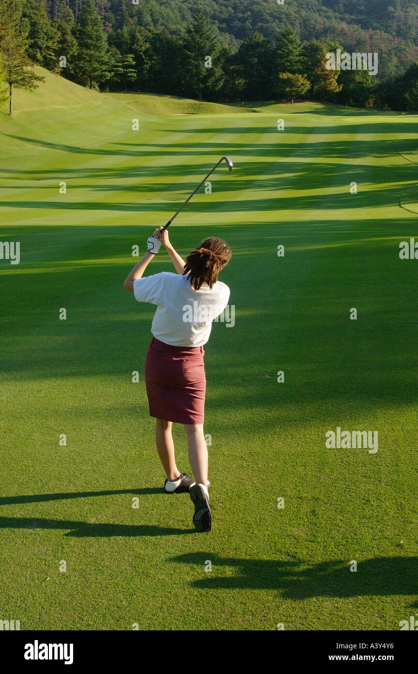 Young Woman Playing Golf Stock Photo - Alamy
