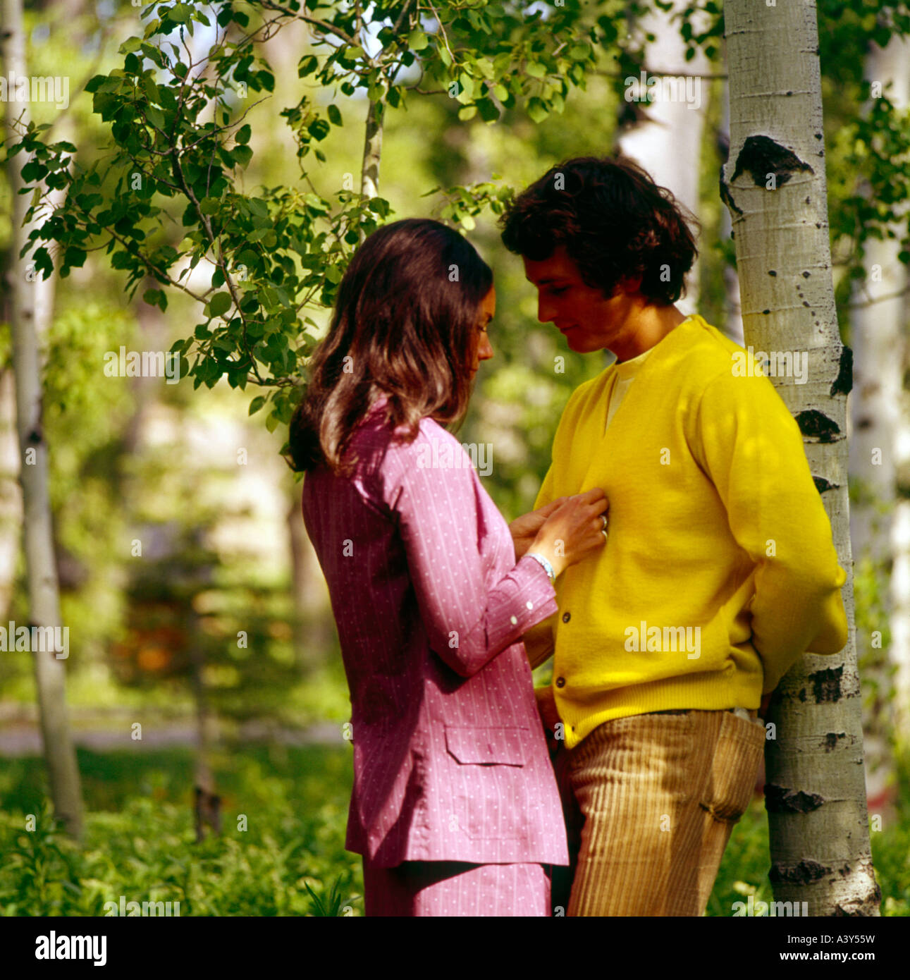 Romantic young couple in close conversation in a woodsy setting Stock ...