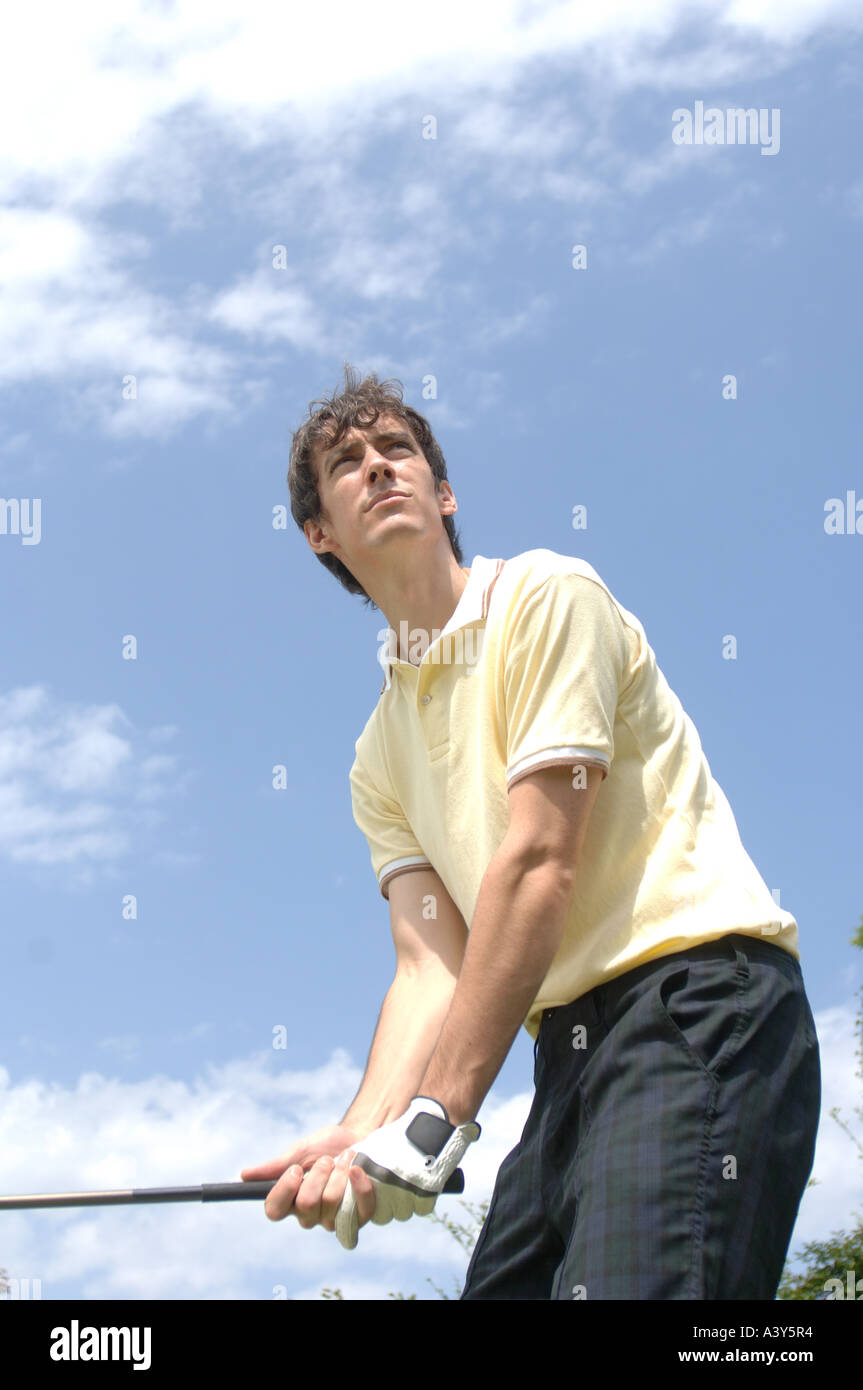 Side view of a man playing a golf shot Stock Photo - Alamy