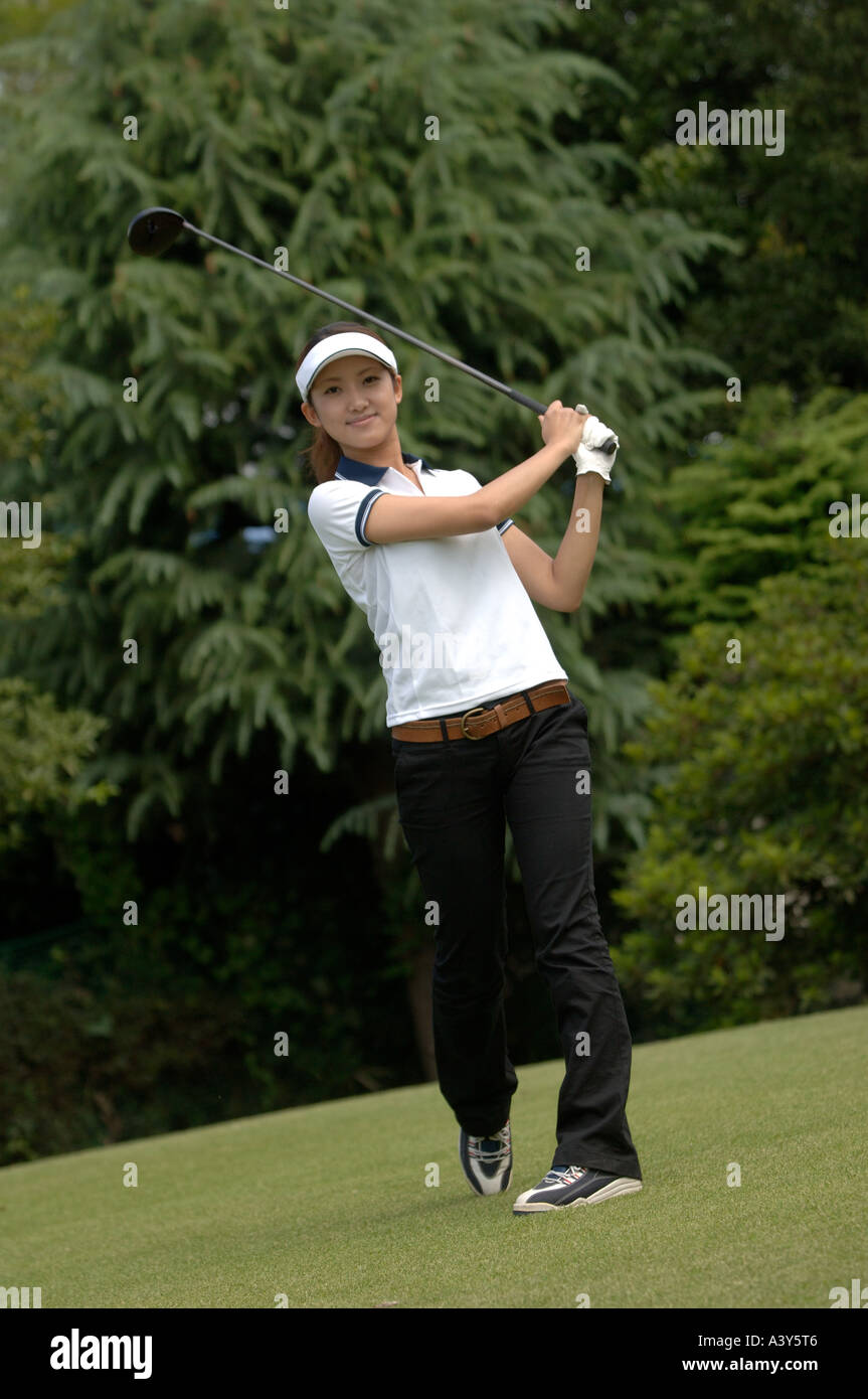 Front view of a woman playing a golf stroke Stock Photo - Alamy