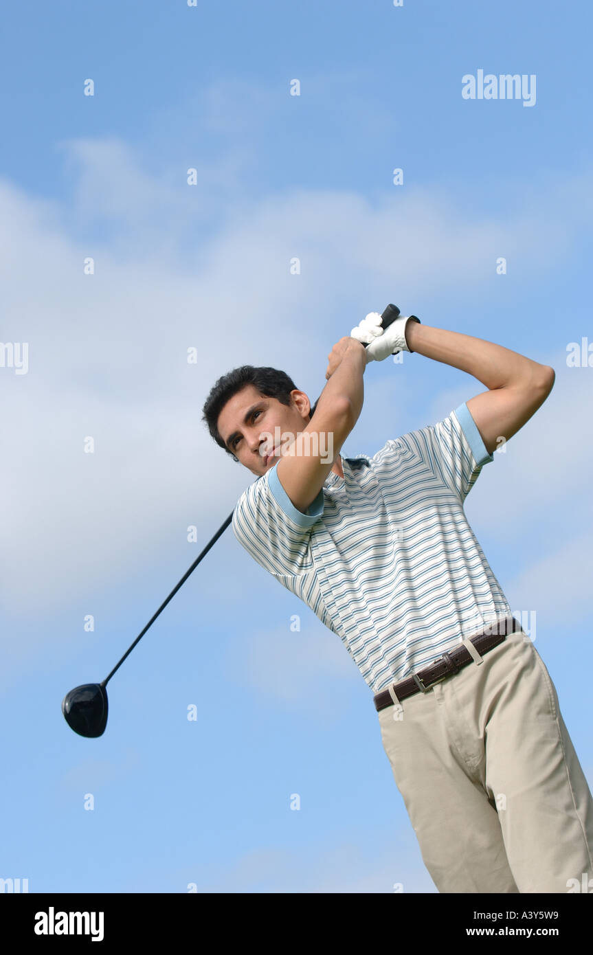 Portrait of a man making a golf swing Stock Photo - Alamy