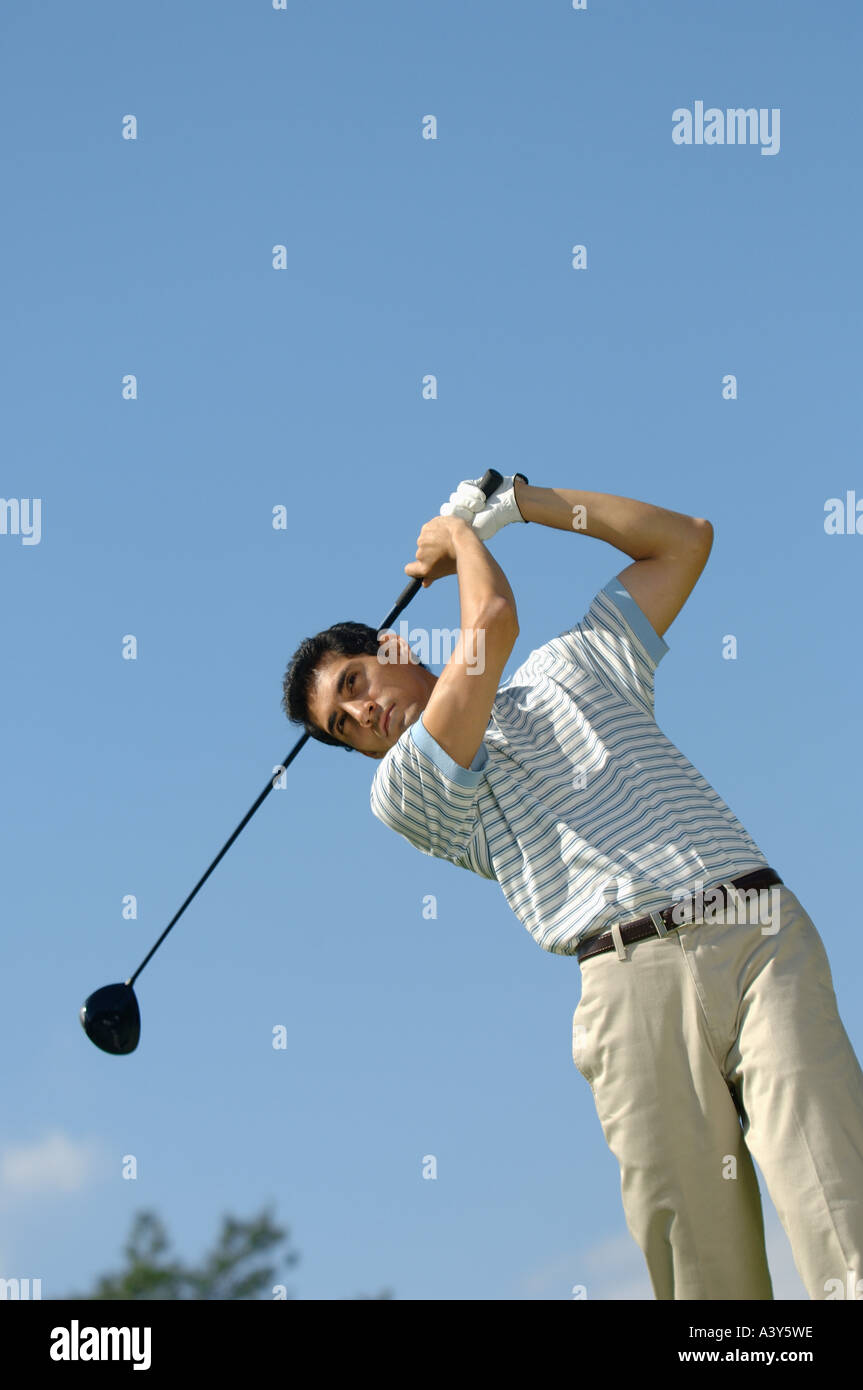 Portrait of a man making a golf swing Stock Photo - Alamy